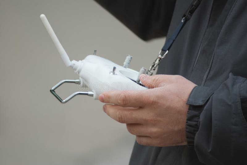 Man Operating Flying Drone with Remote Controller and Smart Phone Stock ...