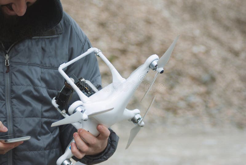 Man Operating Flying Drone with Remote Controller and Smart Phone Stock ...