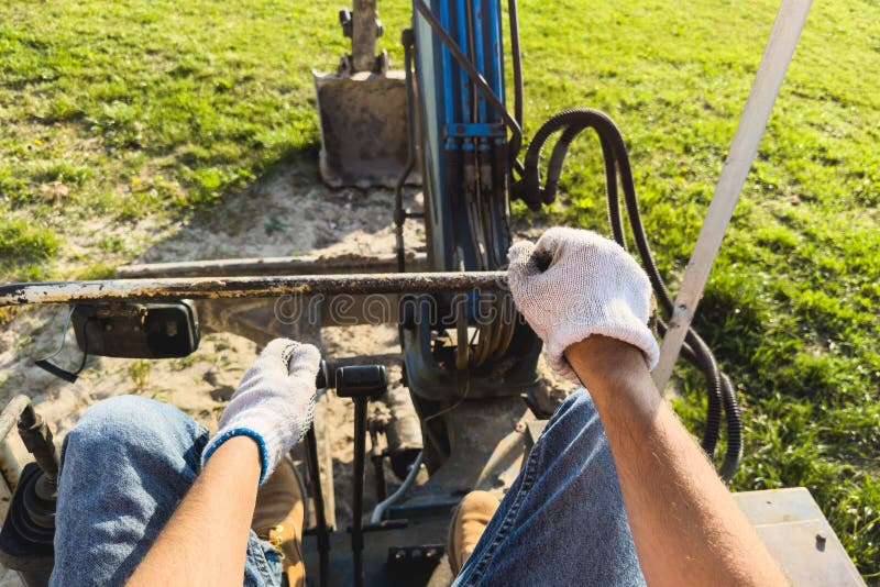 Man Operating His Old Excavator during His Work on a Construction Site ...