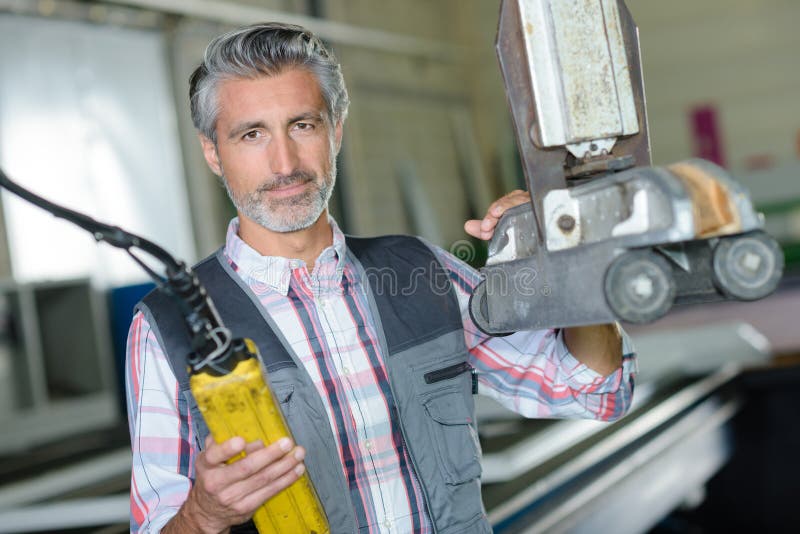 Man operating machine stock image. Image of manufacture - 328786631