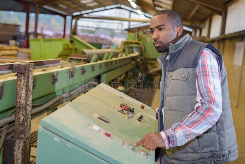 Man Operating Machine at Factory Stock Photo - Image of industry ...