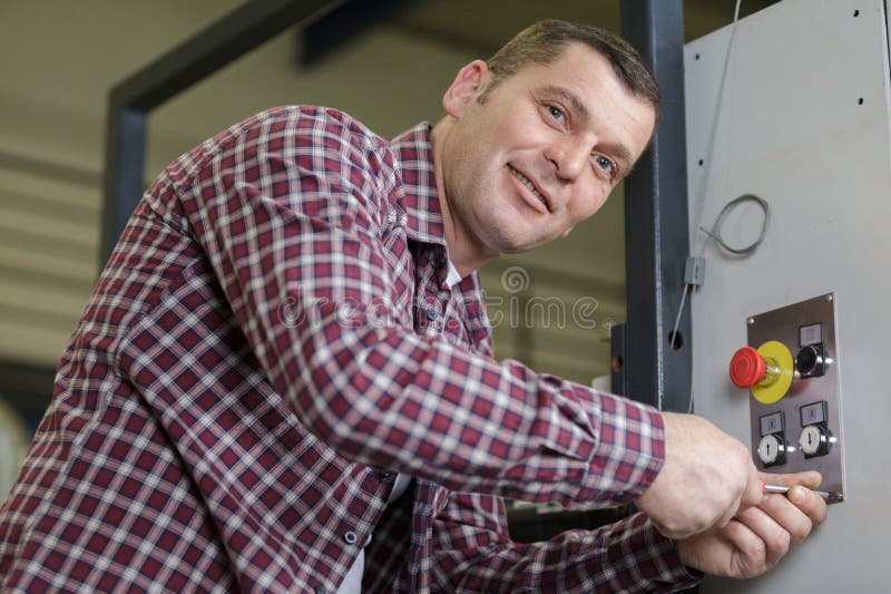 Man Operating Machine in Factory Stock Photo - Image of operating, male ...