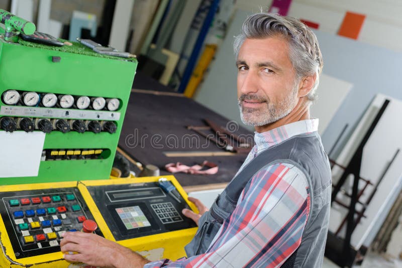 Man operating machinery stock photo. Image of operation - 245734978