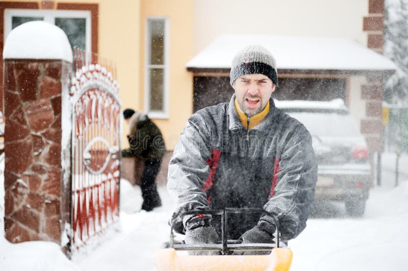 A Man Operating Snow Blower Stock Photo - Image of plastered, frigid ...