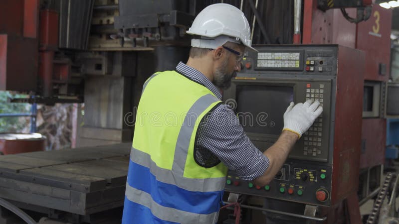 A Man Operation of the Old Machine Via the Remote Computer. a Man ...