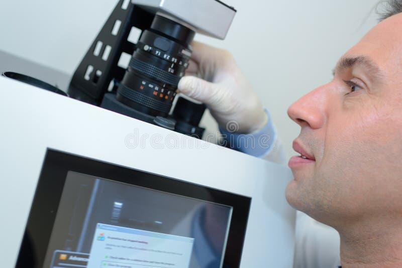 Man with optical device stock photo. Image of product - 130817850