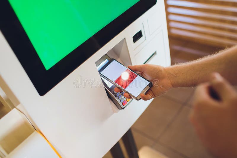 A Man Orders Food in the Touch Screen Terminal with Electronic Menu in ...