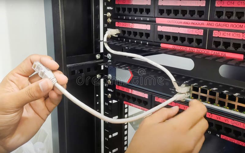 A Man Organizing Server Room Wires and Equipment for Optimal ...