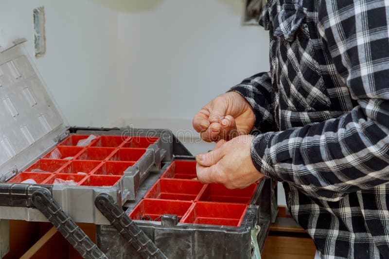 Man Organizing Small Parts in Toolbox while Working at Workshop Stock ...