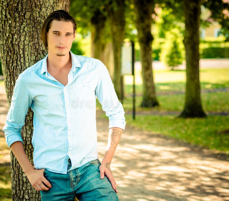 Man Outdoors Leaning on a Tree Stock Image - Image of charm, portrait ...
