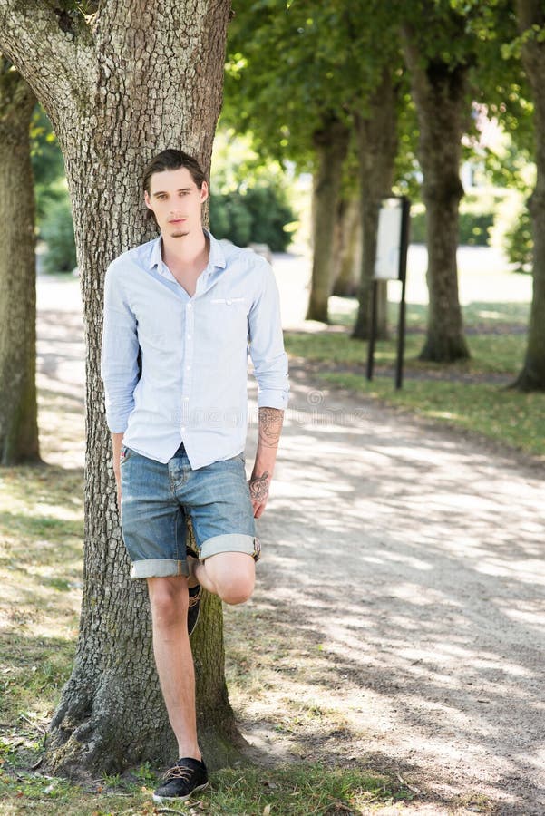 Man Outdoors Leaning on a Tree Stock Image - Image of charm, portrait ...