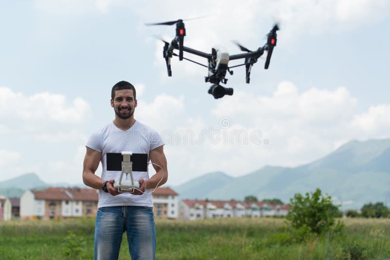 Man Operating a Flying Drone in the Sky Stock Photo - Image of aircraft ...