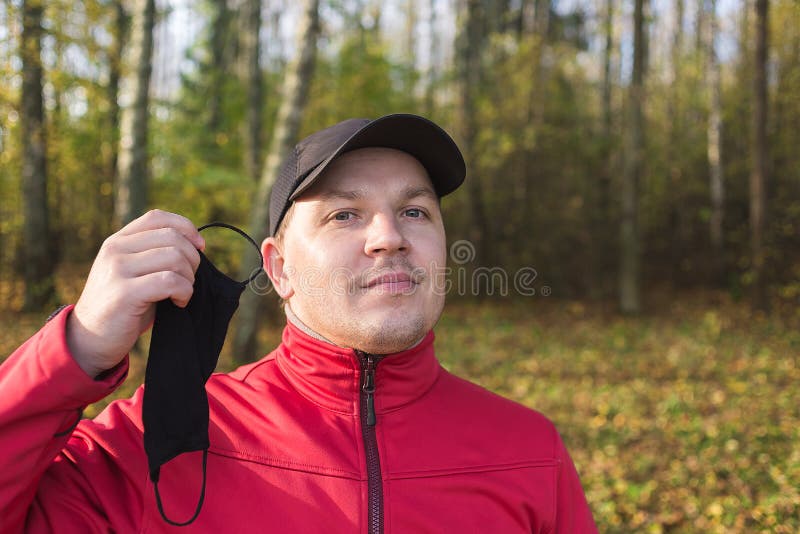 Man Outdoors Takes Off the Mask from Coronavirus. Man in Outdoors Takes ...