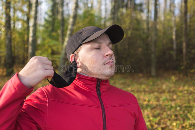 Man Outdoors Takes Off the Mask from Coronavirus. Man in Outdoors Takes ...