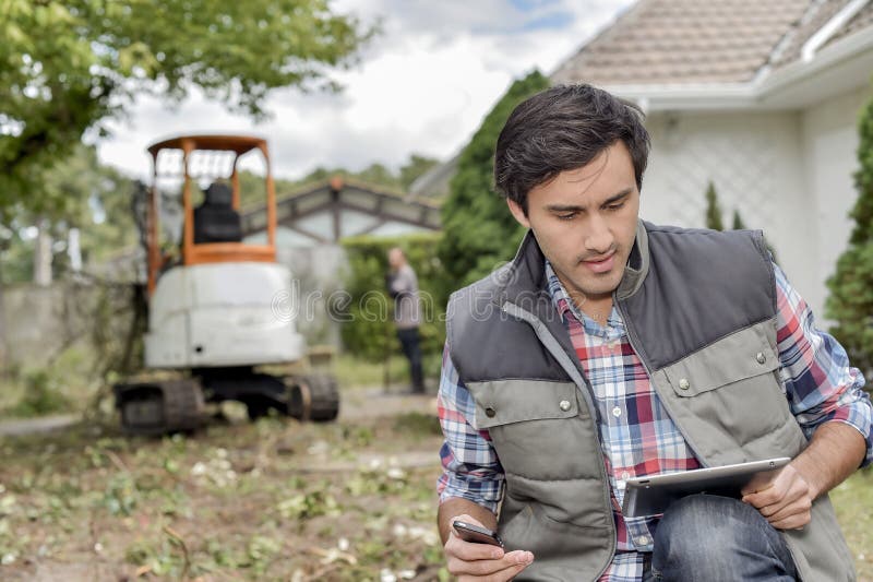 Man Outside Using Tablet Digger in Background Stock Photo - Image of ...