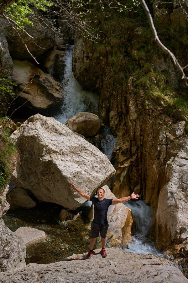 Man Posing by Mountain Waterfall Stock Photo - Image of motion ...