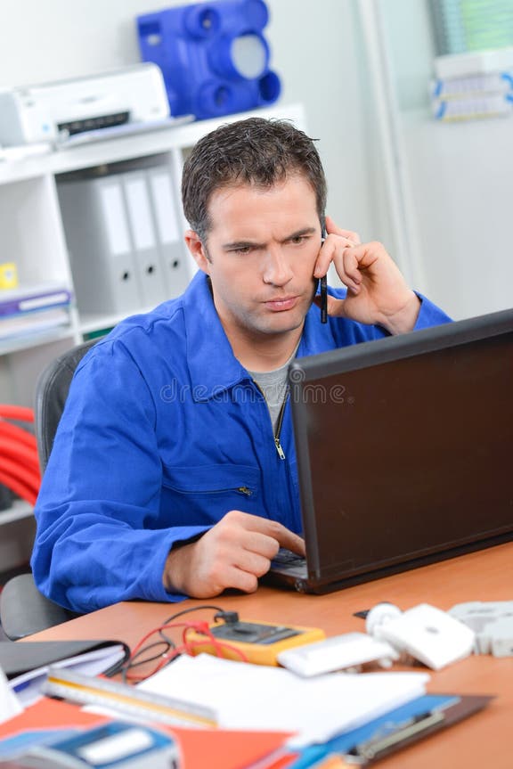 Man in Overalls on Computer Frowning Stock Image - Image of frown ...