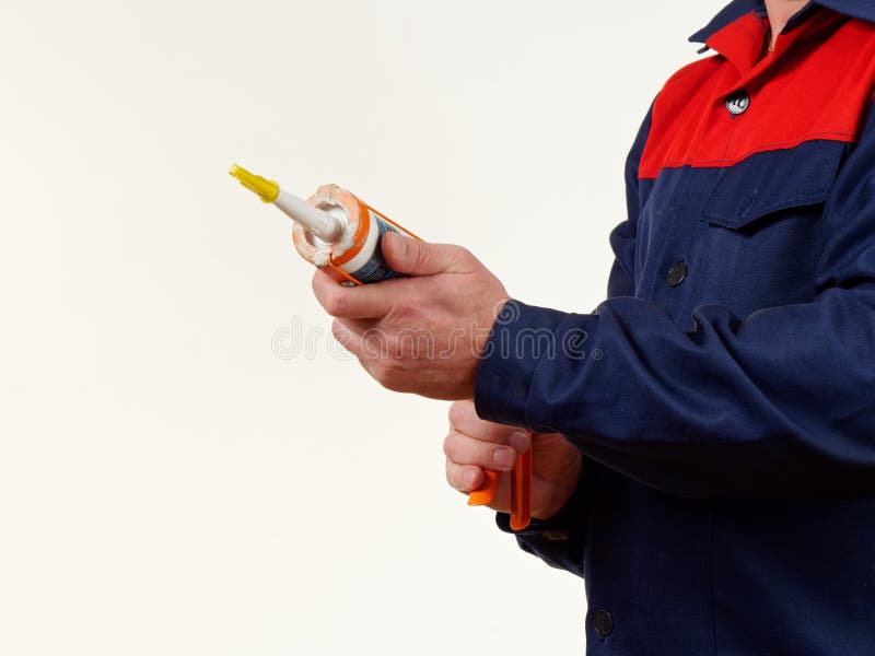 Man in Overalls Holds Tool Nails on White Background Stock Photo ...