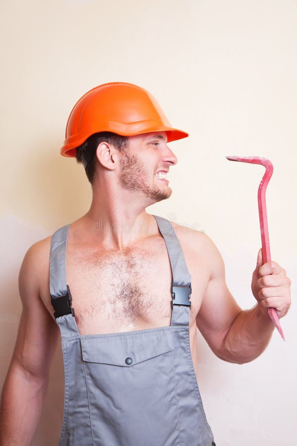 Man in Overalls with a Tool for Dismantling Stock Photo - Image of ...