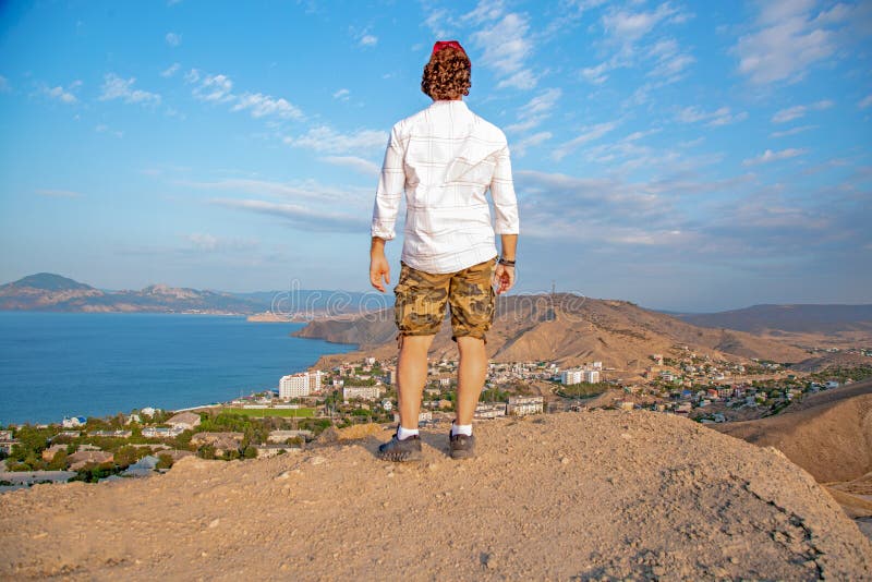 A Man Overlooking a Panoramic View of a Beautiful Coastline from the ...