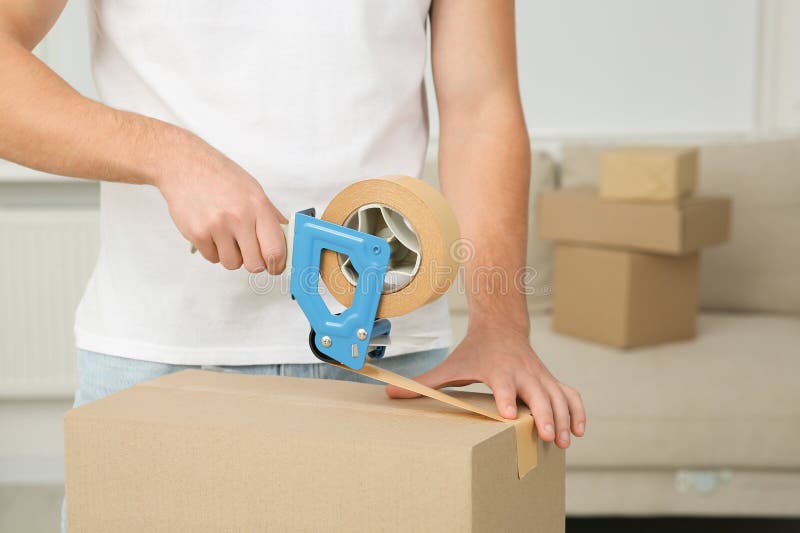 Man Packing Box with Adhesive Tape Indoors, Closeup Stock Photo - Image ...