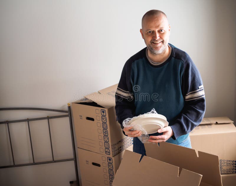 Man packing plates stock image. Image of face, smiling - 67138271