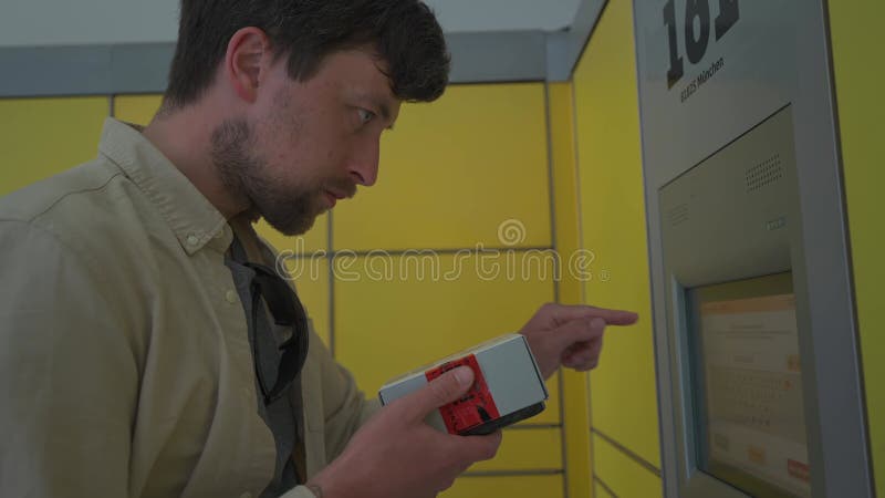 Man at Packing Station Using Screen and Holding Box for Self Shipment ...