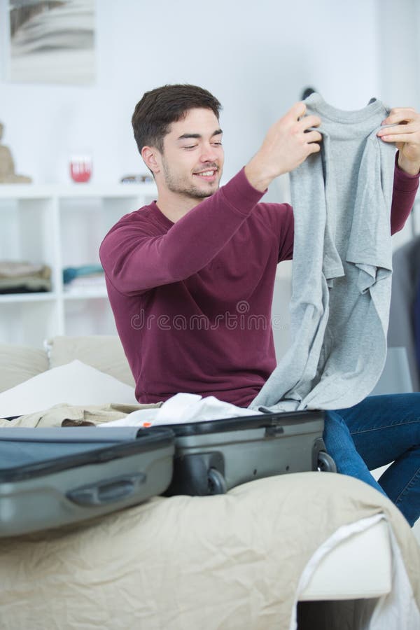 Man packing suitcase stock photo. Image of tourist, tourism - 310493684