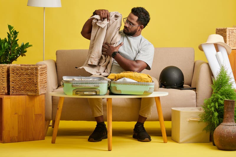 Man Packing Suitcase stock image. Image of table, traveler - 266128853