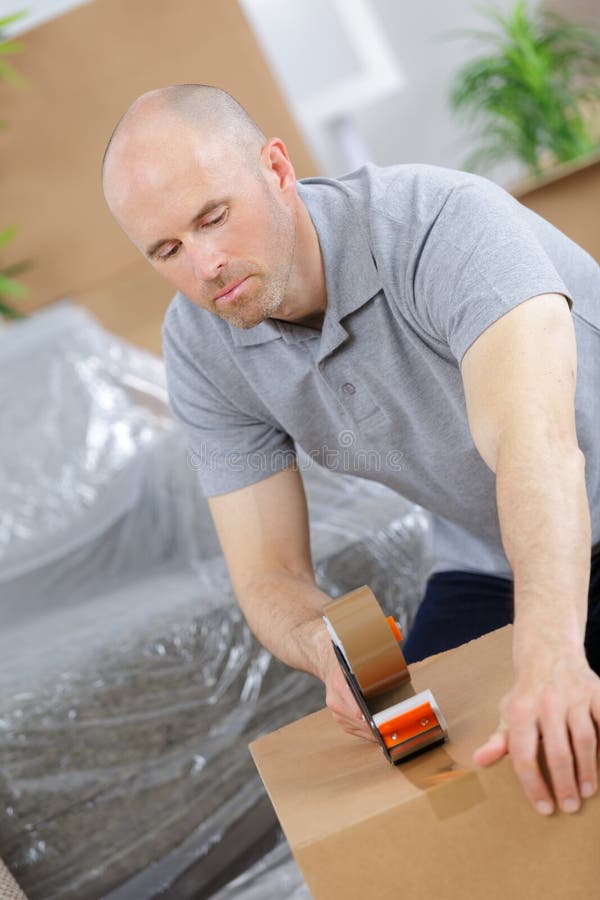 Taping Up Boxes stock photo. Image of beautiful, couple - 5343950