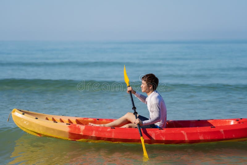 Man Paddling a Kayak Boat in Sea Stock Photo - Image of boat, kayaker ...
