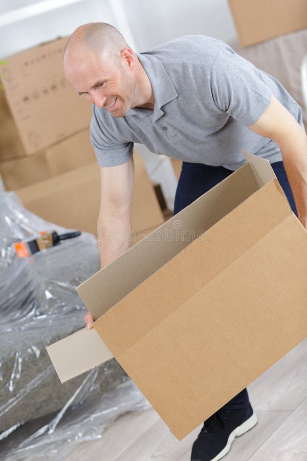 Man Painfully Carrying Boxes Stock Photo - Image of carton, painful ...