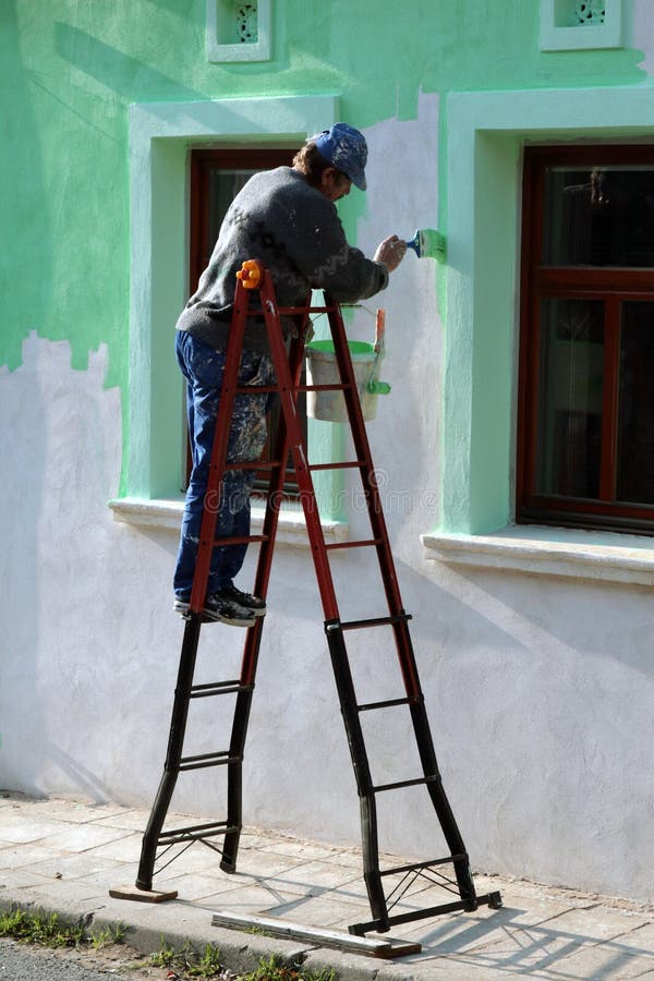 Man paint the house wall stock image. Image of paint, careful - 1482599