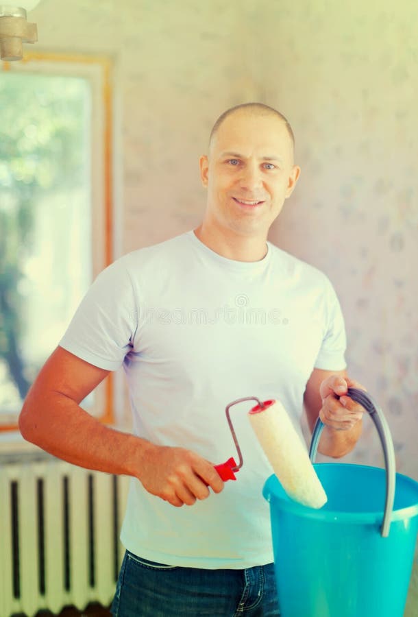 Man with paint roller stock photo. Image of person, industrial - 89545738