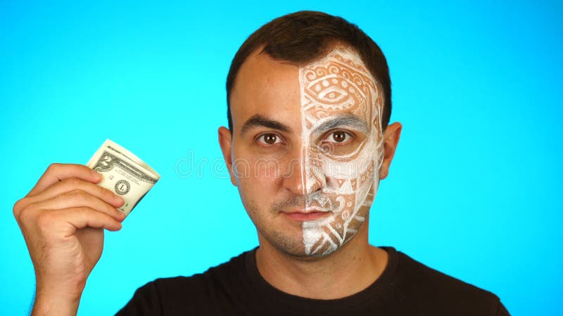 Man with Painted Face Holding 2 Dollars Banknote on Blue Background ...