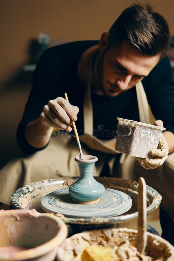 Man Painting Handmade Pottery at Ceramic Workshop Stock Photo - Image ...
