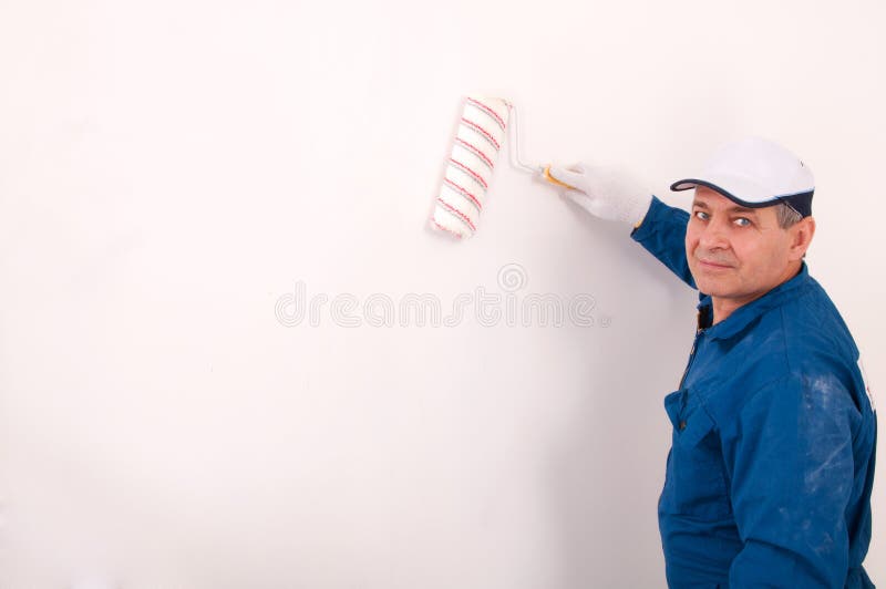 Man painting the wall stock photo. Image of paintings - 19467806
