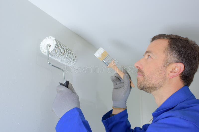 Man Painting Wall in Diy Concept Stock Photo - Image of room, coveralls ...