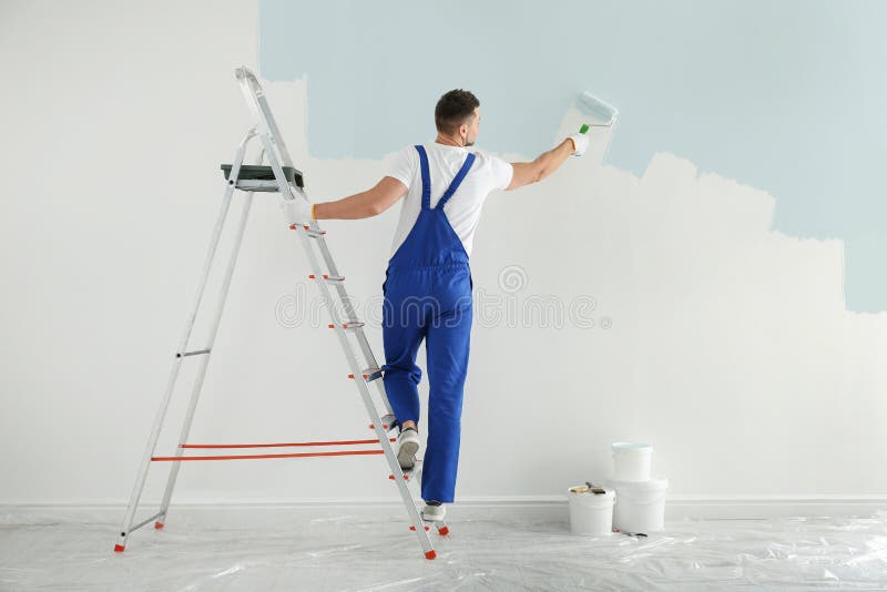 Man Painting Wall with Light Blue Dye Indoors, Back View Stock Photo ...