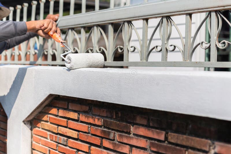 Man Painting a Wall Outside with Roller for House Decoration. Stock ...