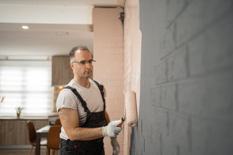 Man Painting Wall with Paint Roller Stock Photo - Image of ...