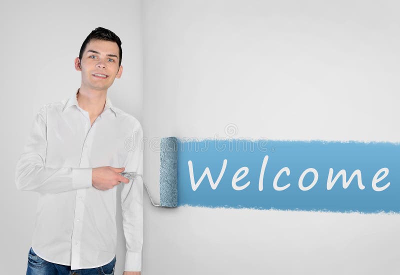 Man Painting Welcome Word on Wall Stock Image - Image of casual, camera ...