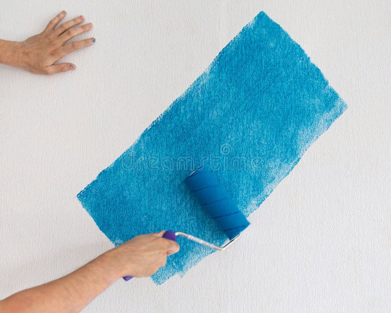 Man Paints a White Wall with a Blue Paint with Roller Stock Image ...