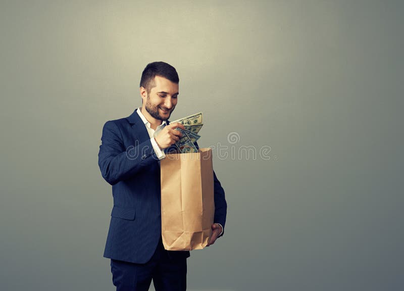 Man Paper Bag Money Over Dark Stock Photos - Free & Royalty-Free Stock ...