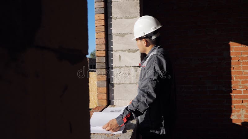 Man with Paper Draft in Building Under Construction Stock Footage ...