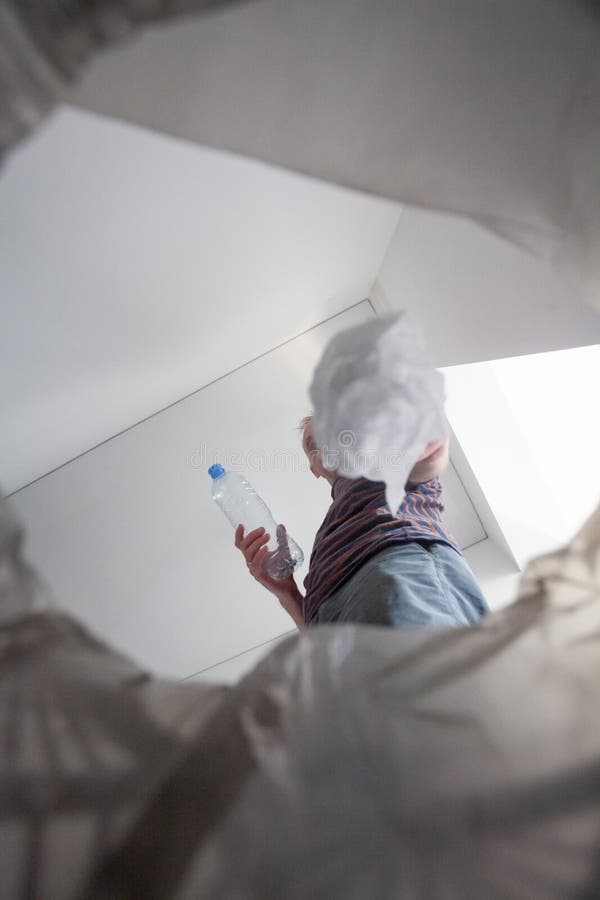 Man with Paper Napkin and Plastic Bottle Separating Waste at Home Stock ...