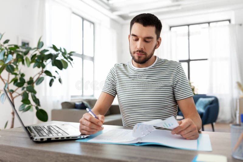 Man with Papers and Laptop Working at Home Office Stock Photo - Image ...