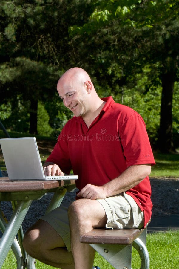 Man in the Park with a Laptop - Vertical Stock Photo - Image of ...