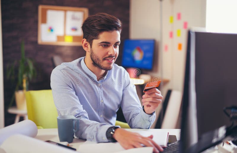Man Paying with Credit Card on Computer Stock Photo - Image of handsome ...