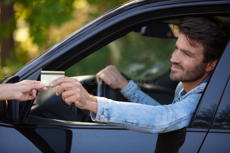 Man Paying with Credit Card while Driving Car Stock Image - Image of ...